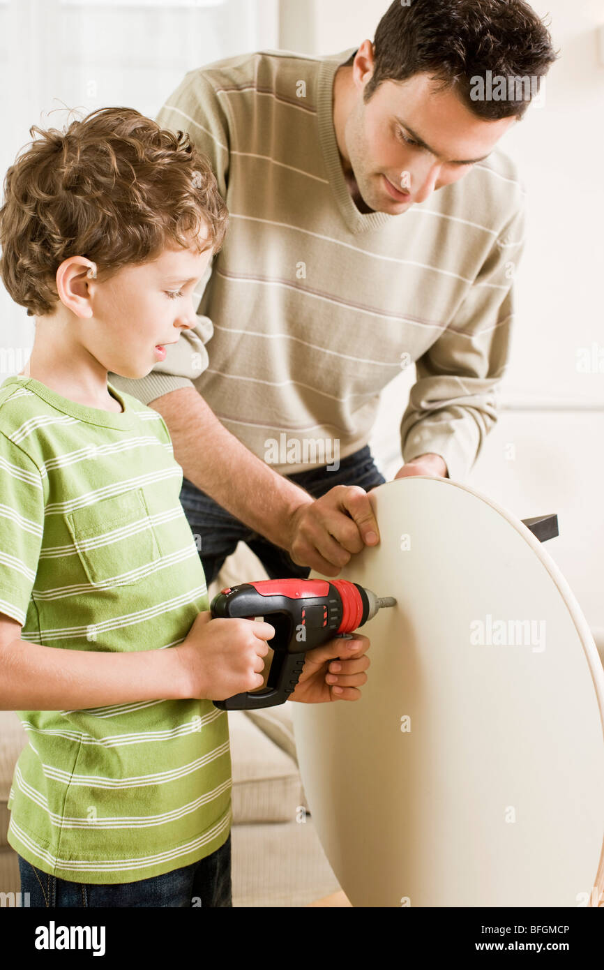 father and son fixing table Stock Photo - Alamy