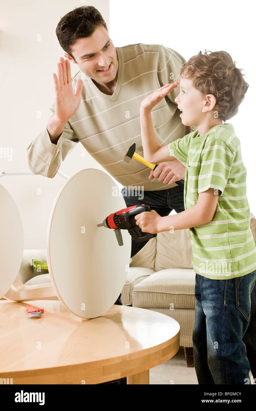 father and son fixing table Stock Photo - Alamy