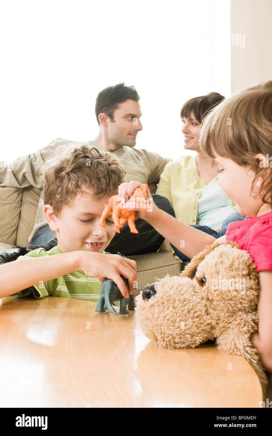 parents talking and kids playing Stock Photo - Alamy