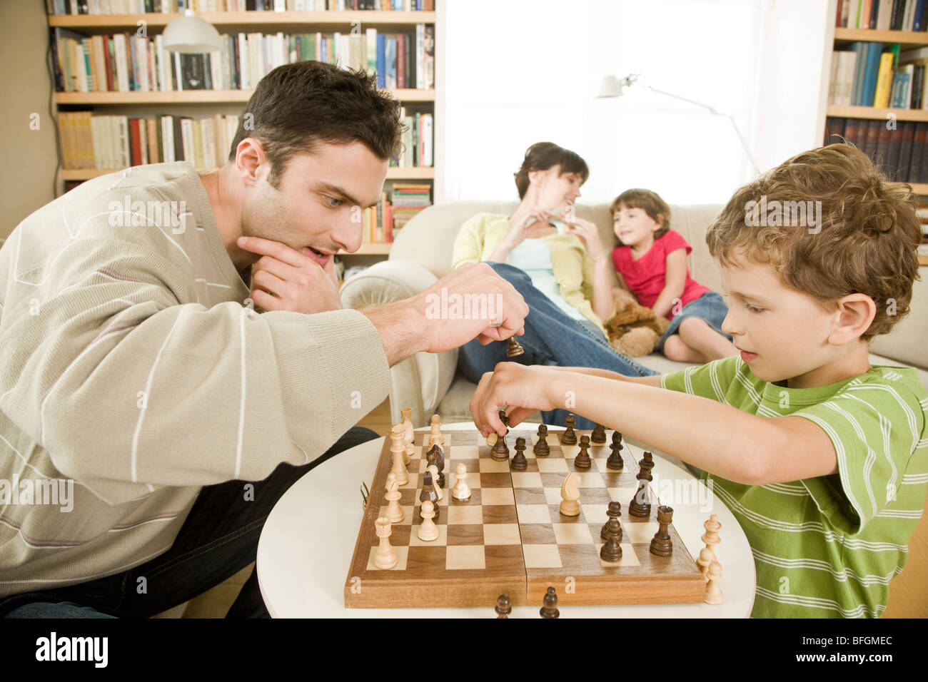 father and son playing chess Stock Photo - Alamy