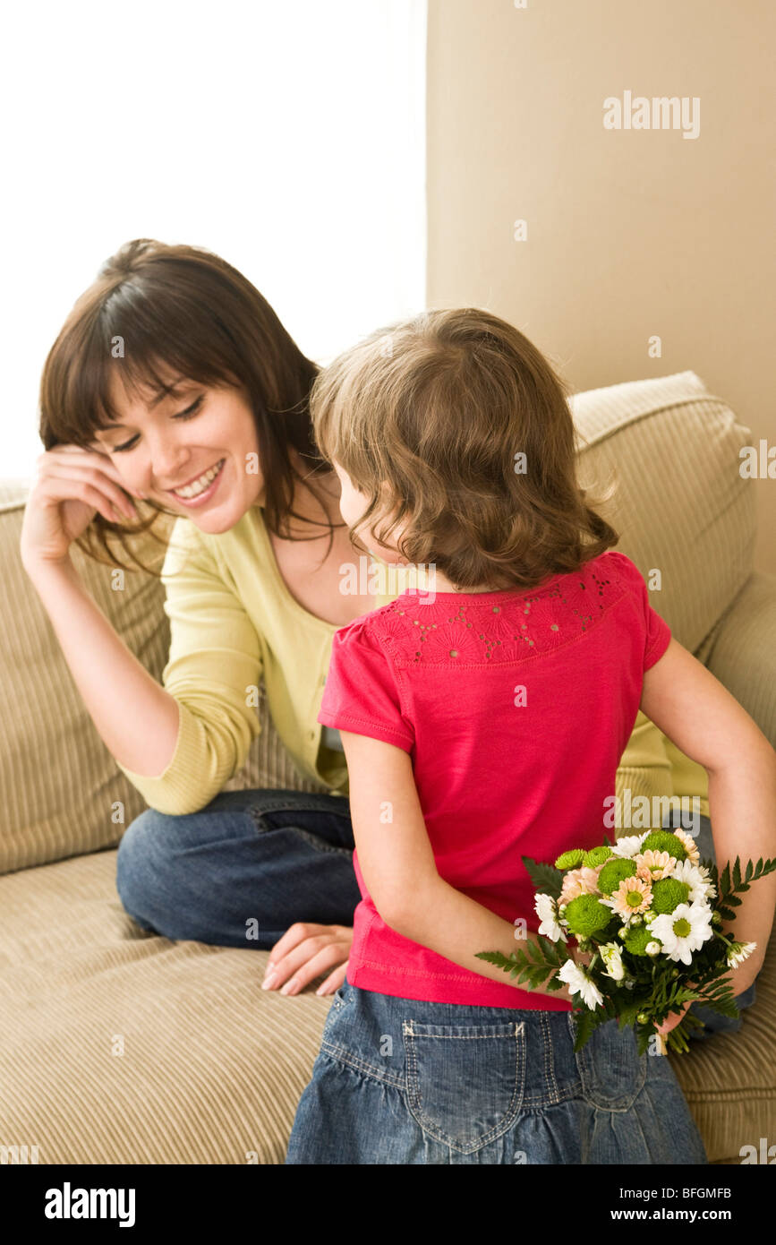 daughter giving mother flowers Stock Photo - Alamy