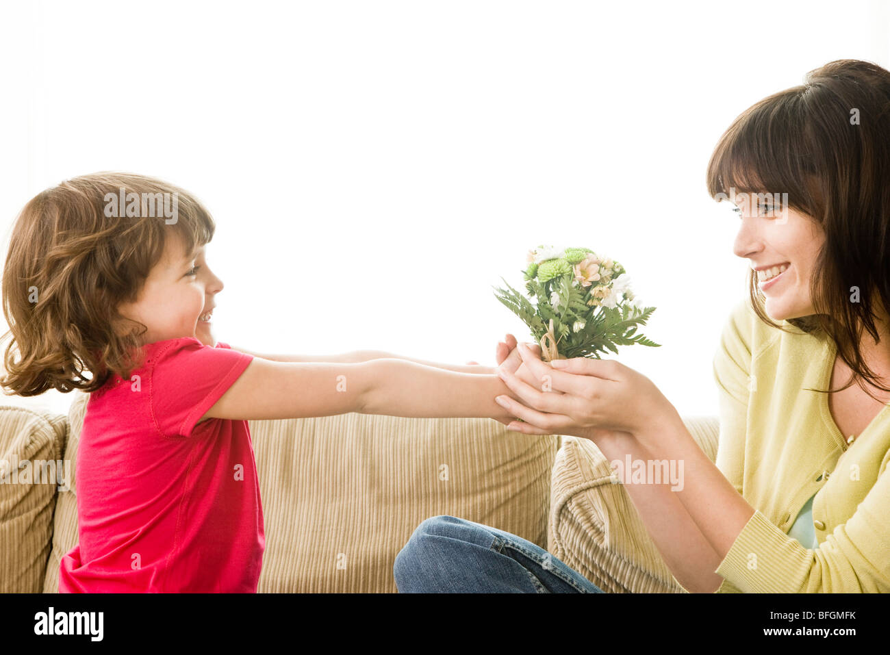 daughter giving mother flowers Stock Photo - Alamy