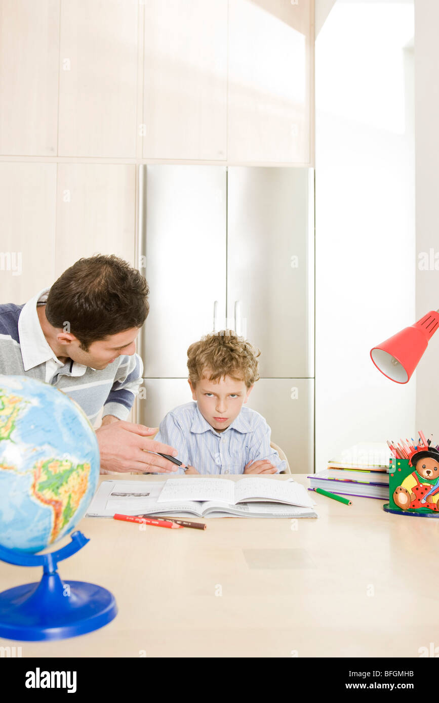 dad helping son with homework Stock Photo - Alamy