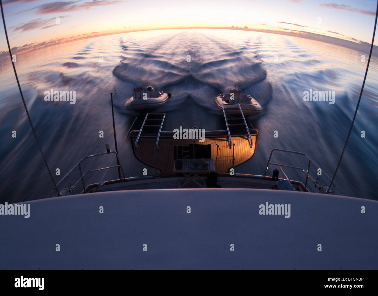 the sailing yacht atlanta tows its two tenders across the exumas bank ...