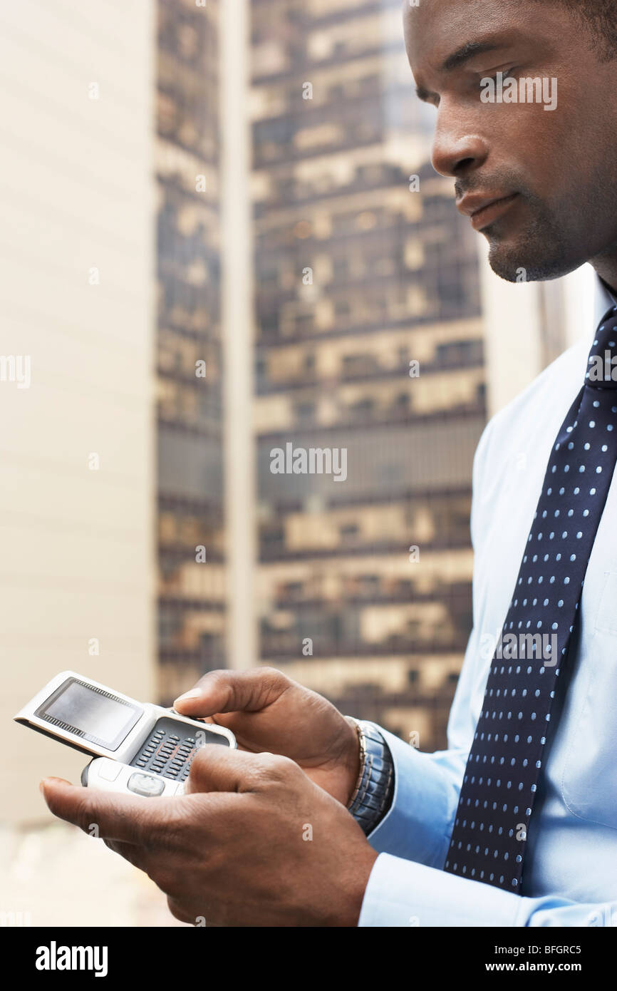 Businessman Using PDA, standing outdoors, side view, cropped Stock ...