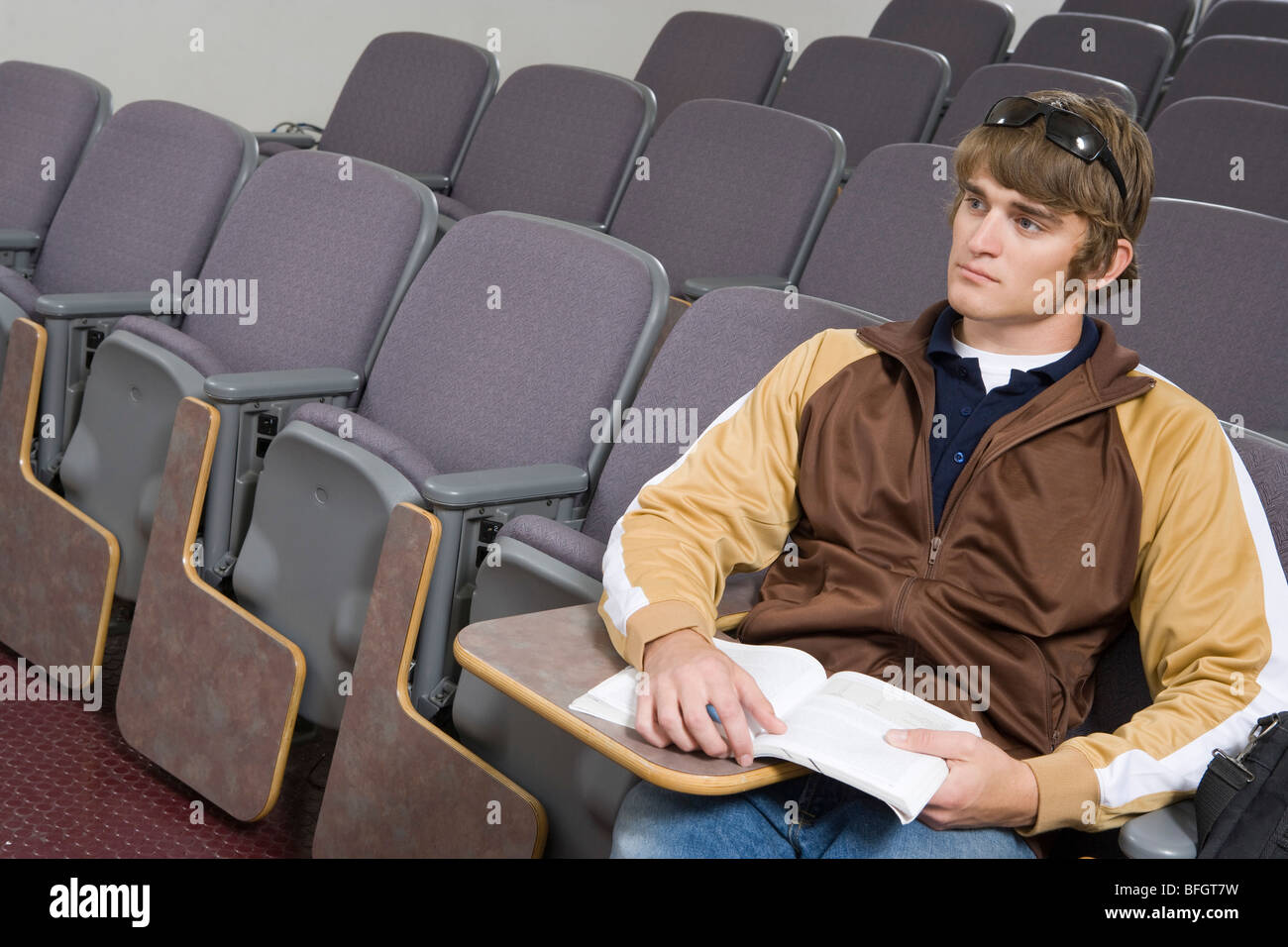 Male University student sitting in lecture hall Stock Photo - Alamy
