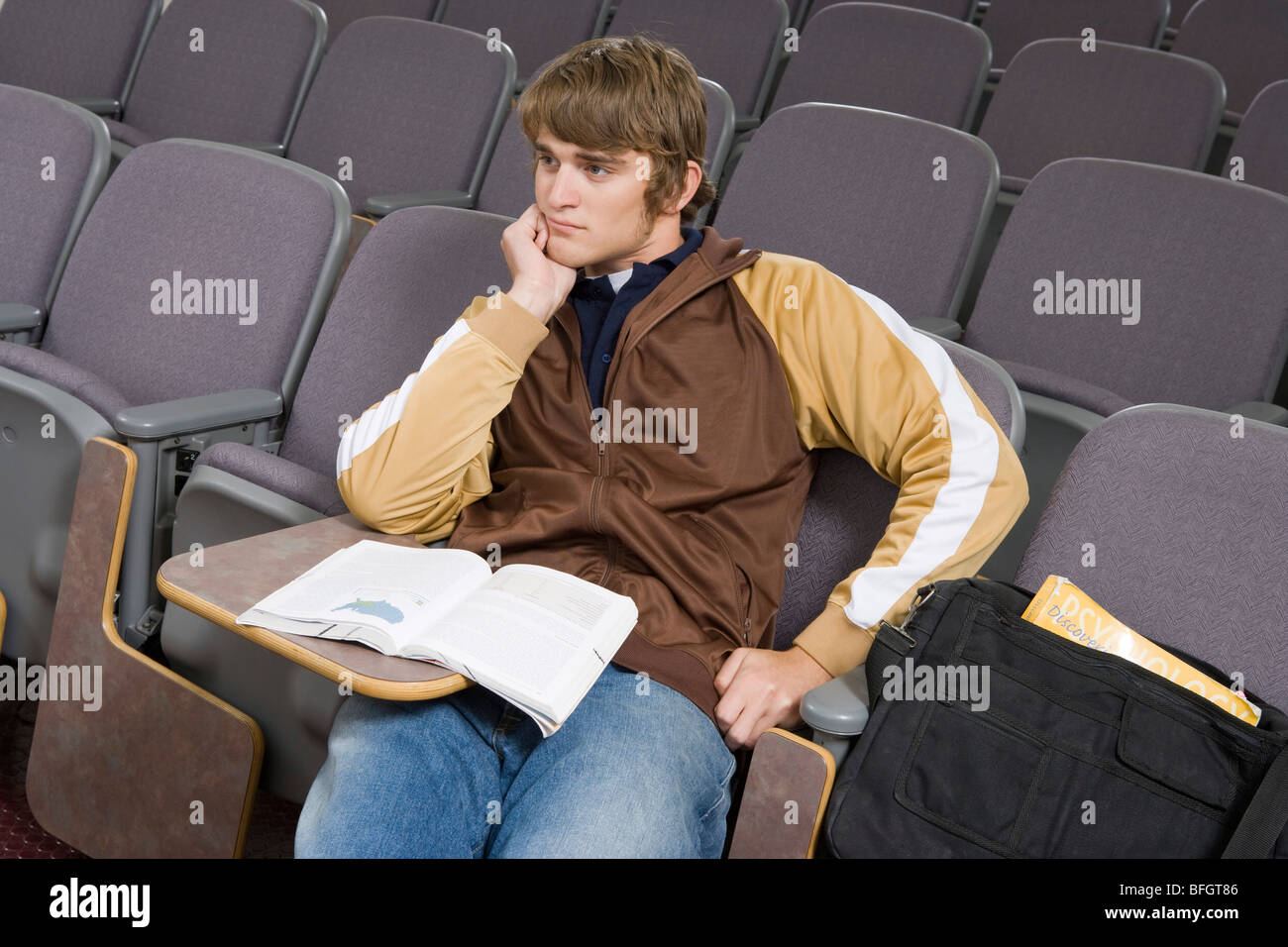 Male University student sitting in lecture hall Stock Photo - Alamy
