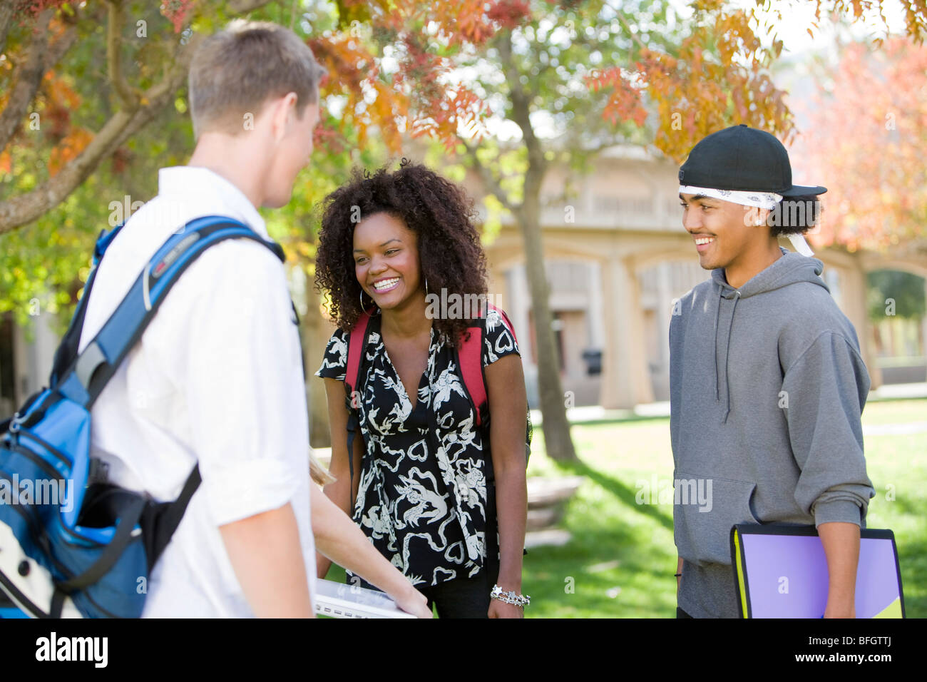Young students having chat Stock Photo - Alamy