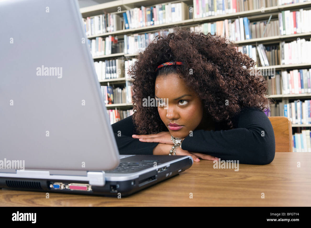 Female university student learning in library Stock Photo - Alamy