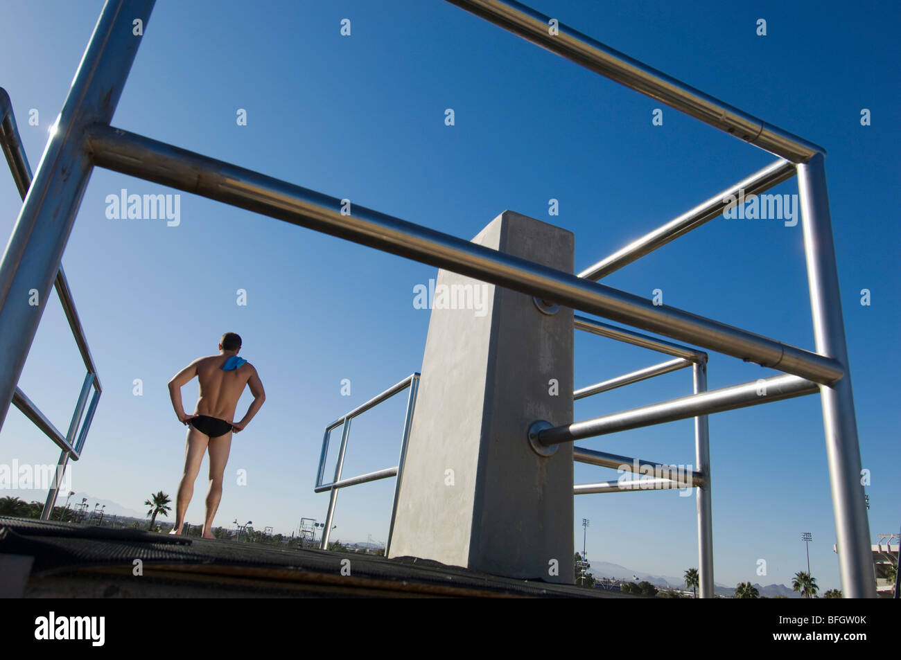 Swimmer standing on diving board Stock Photo - Alamy