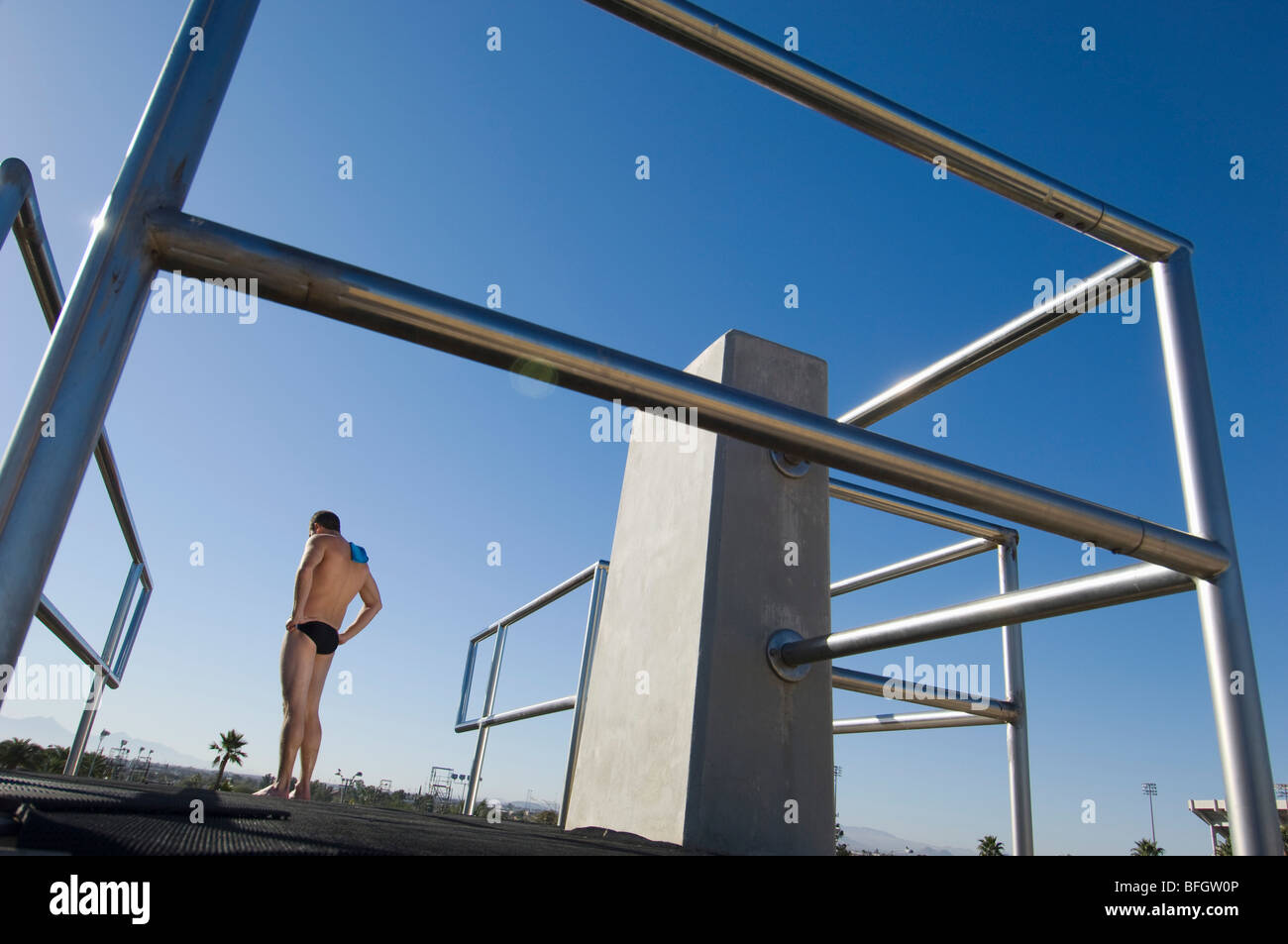 Swimmer standing on diving board Stock Photo - Alamy