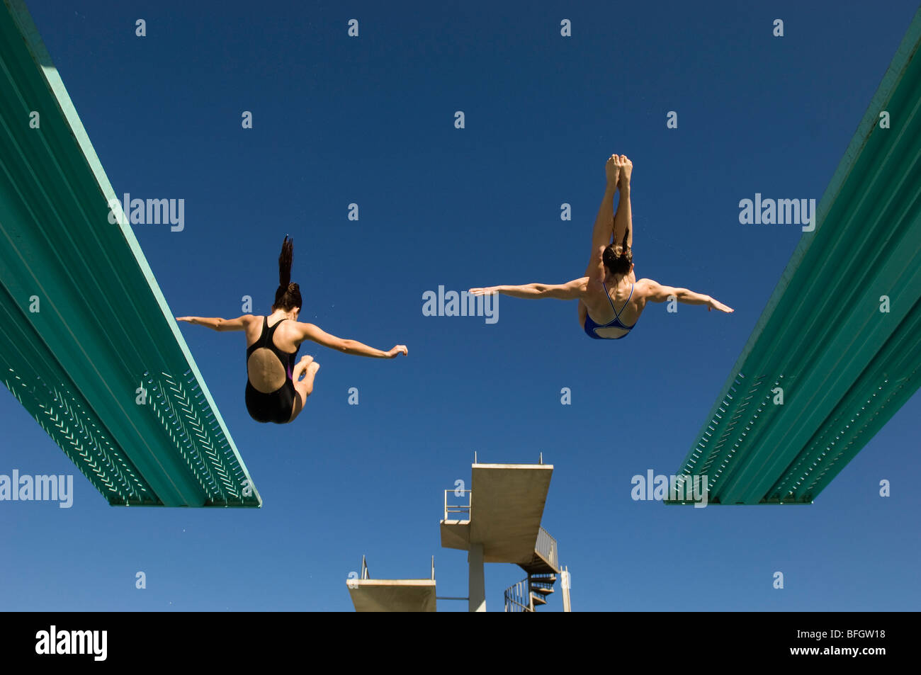 Two women diving from diving board Stock Photo - Alamy