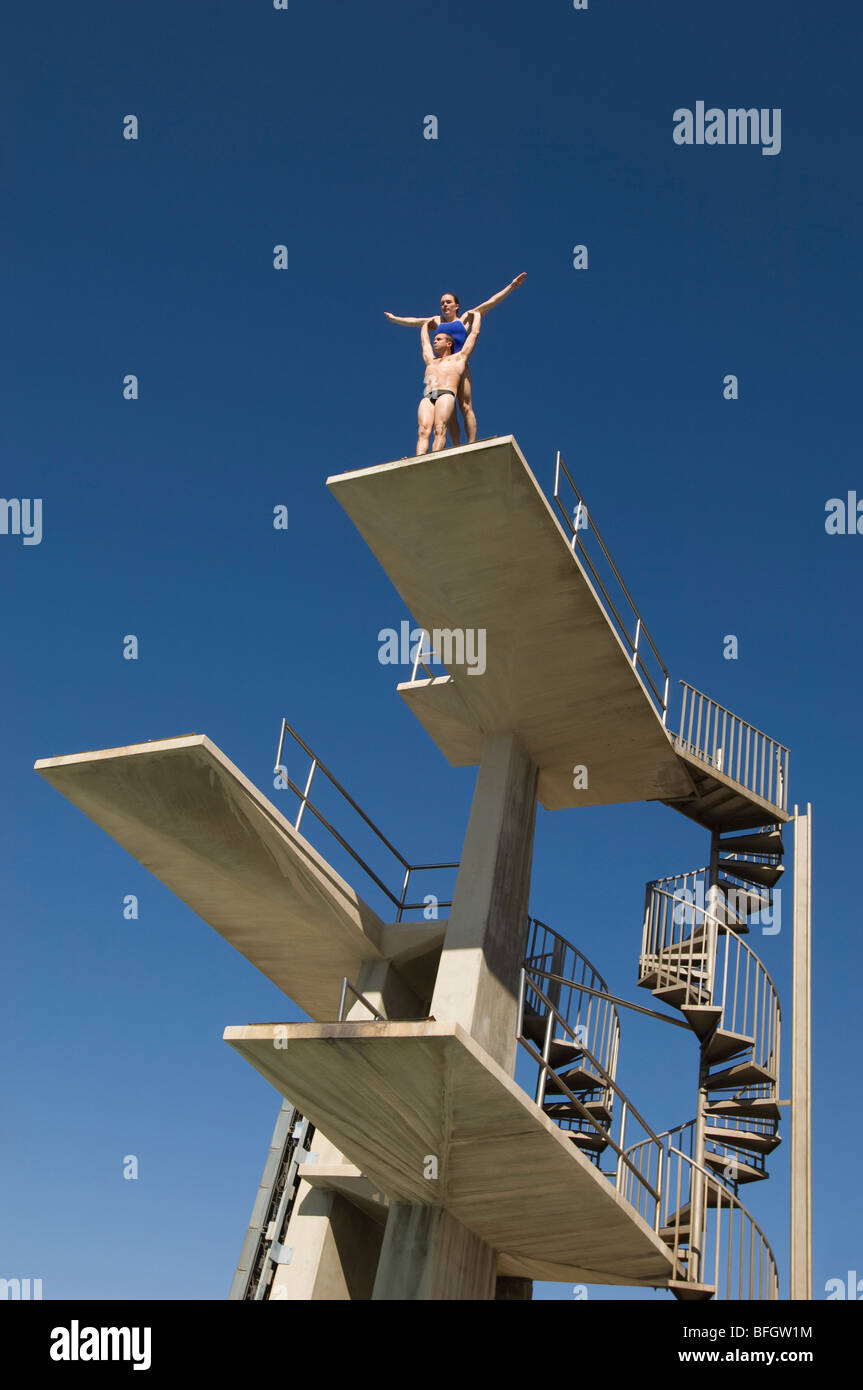 Two swimmers standing on diving board Stock Photo - Alamy
