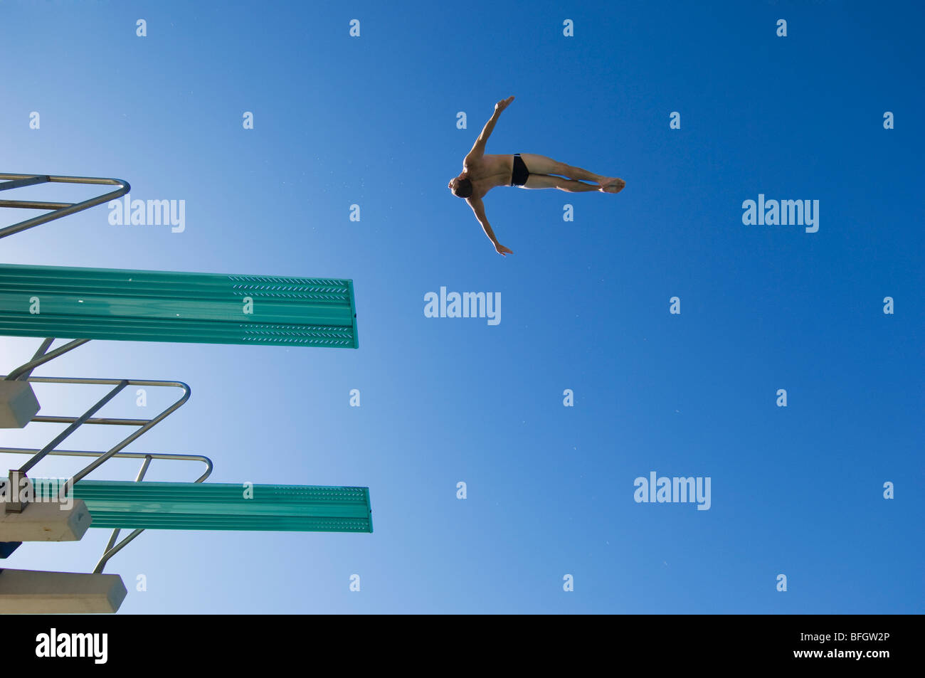 Young man diving from diving board Stock Photo - Alamy