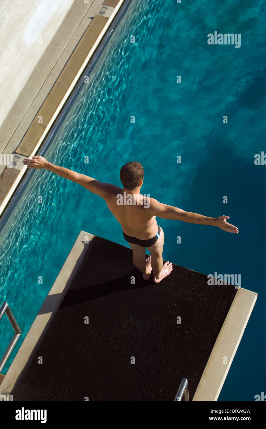 Male swimmer standing on diving board Stock Photo - Alamy