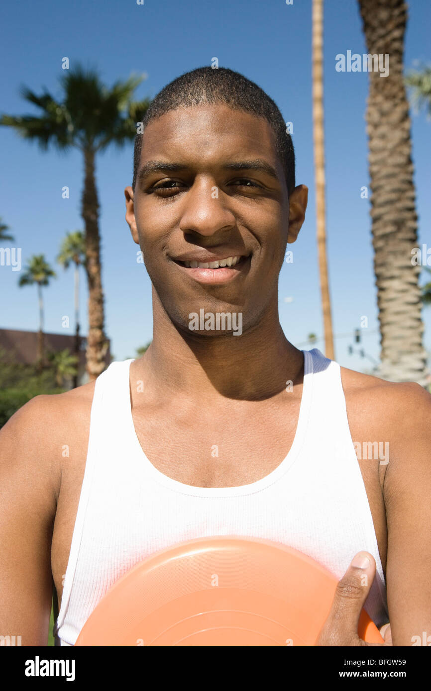Young man holding frisbee, outdoors, portrait Stock Photo - Alamy