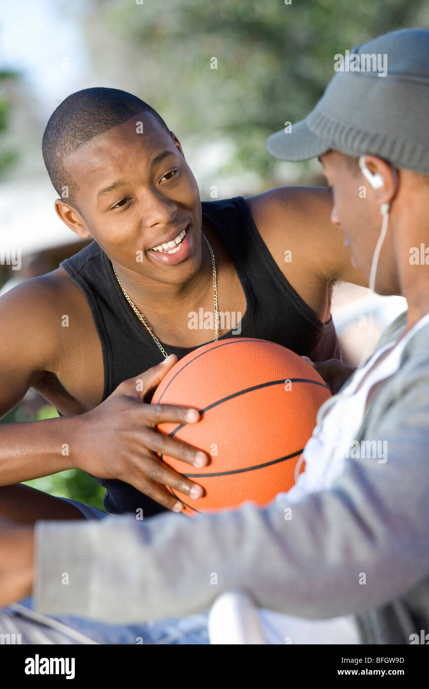 Two Young Men with Basketball, Talking Stock Photo - Alamy