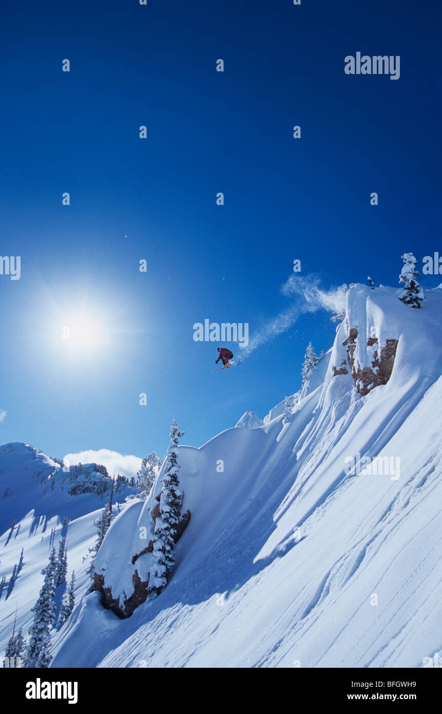 Skier jumping from mountain ledge Stock Photo - Alamy