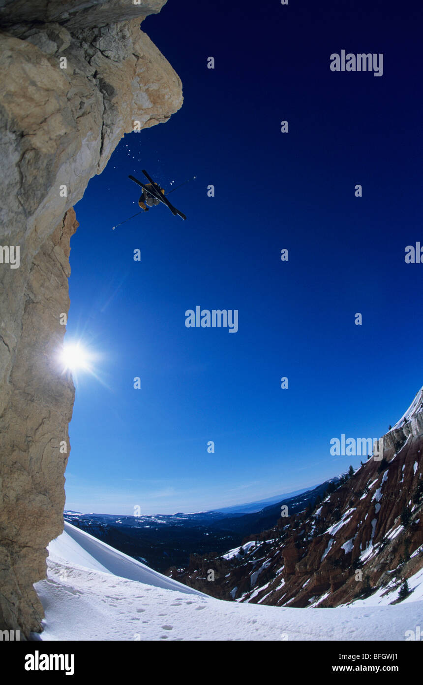 Skier jumping from mountain ledge Stock Photo - Alamy