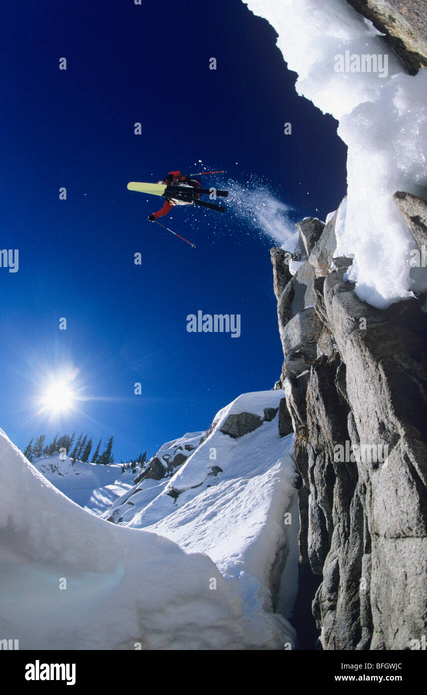 Skier jumping from cliff in mountains Stock Photo - Alamy