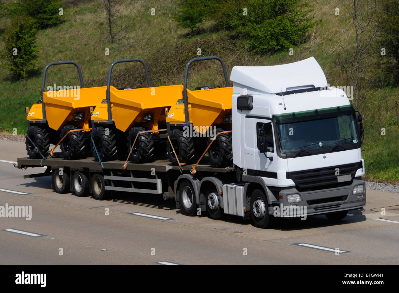 M25 motorway low loader articulated lorry with new dumper trucks Stock ...
