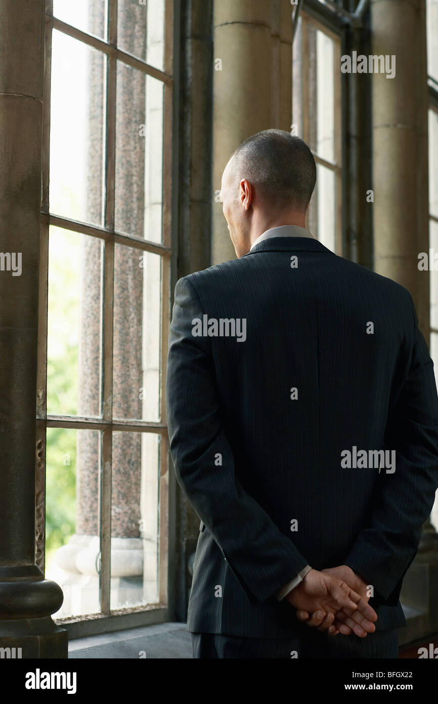 Businessman Looking Out Window Stock Photo - Alamy