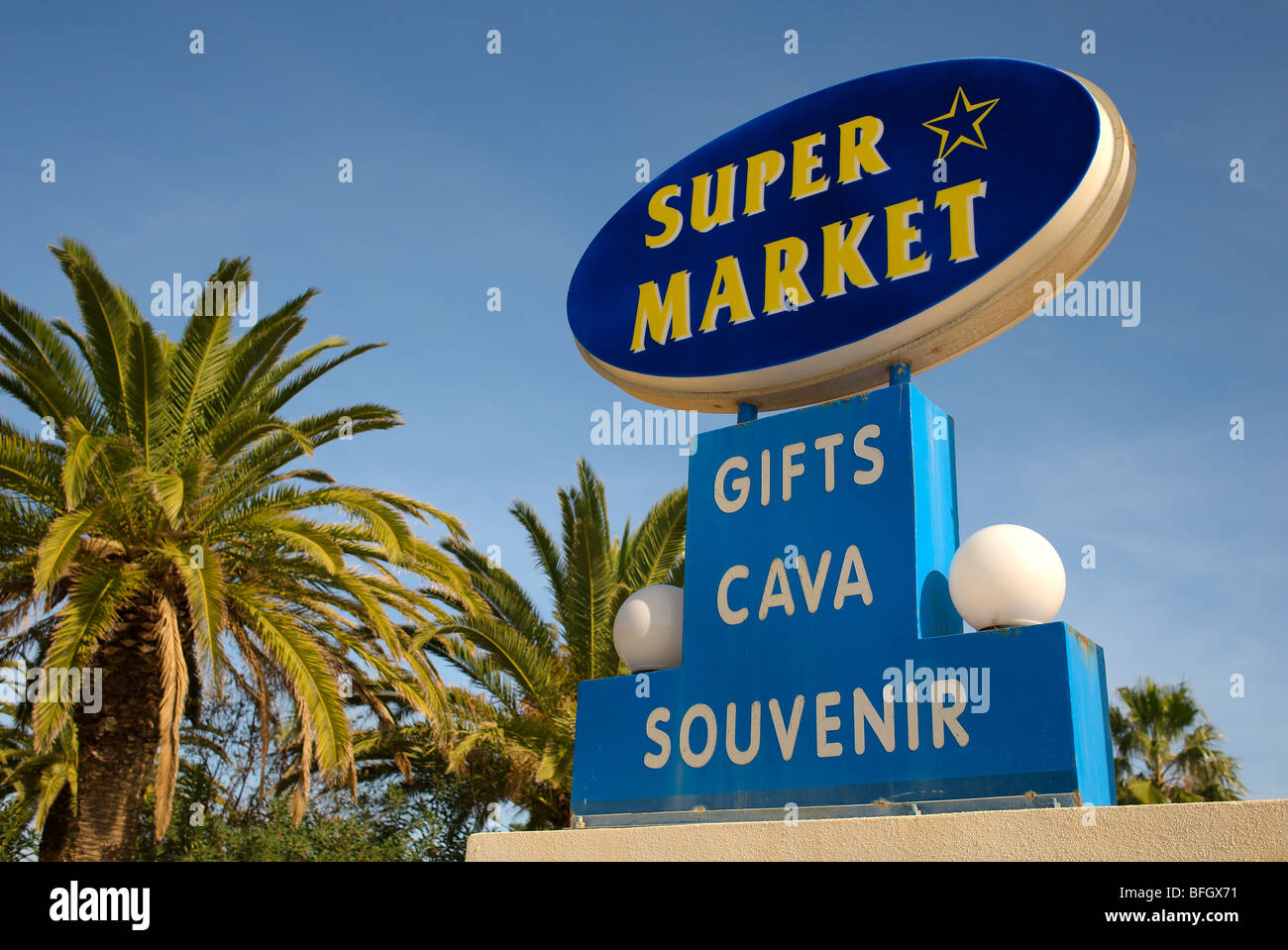 Supermarket sign and palm trees Crete Greece Stock Photo - Alamy