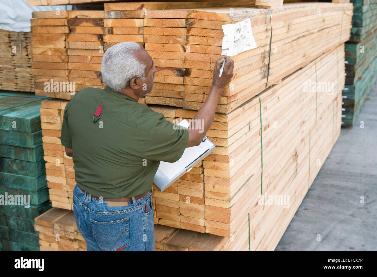 Senior man stock-taking in warehouse Stock Photo - Alamy