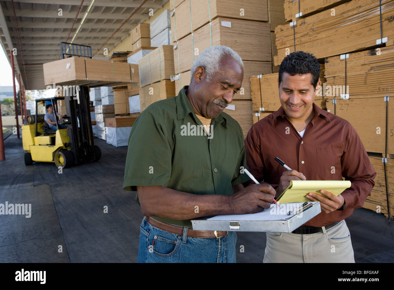 Men stock-taking in warehouse Stock Photo - Alamy