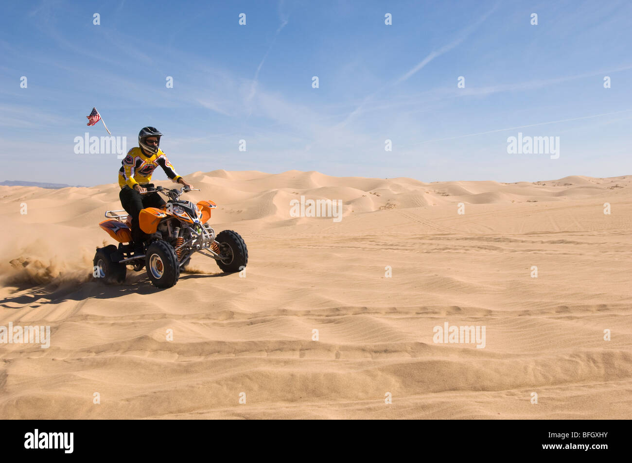 Young Man Riding ATV Over Sand Dune Stock Photo - Alamy