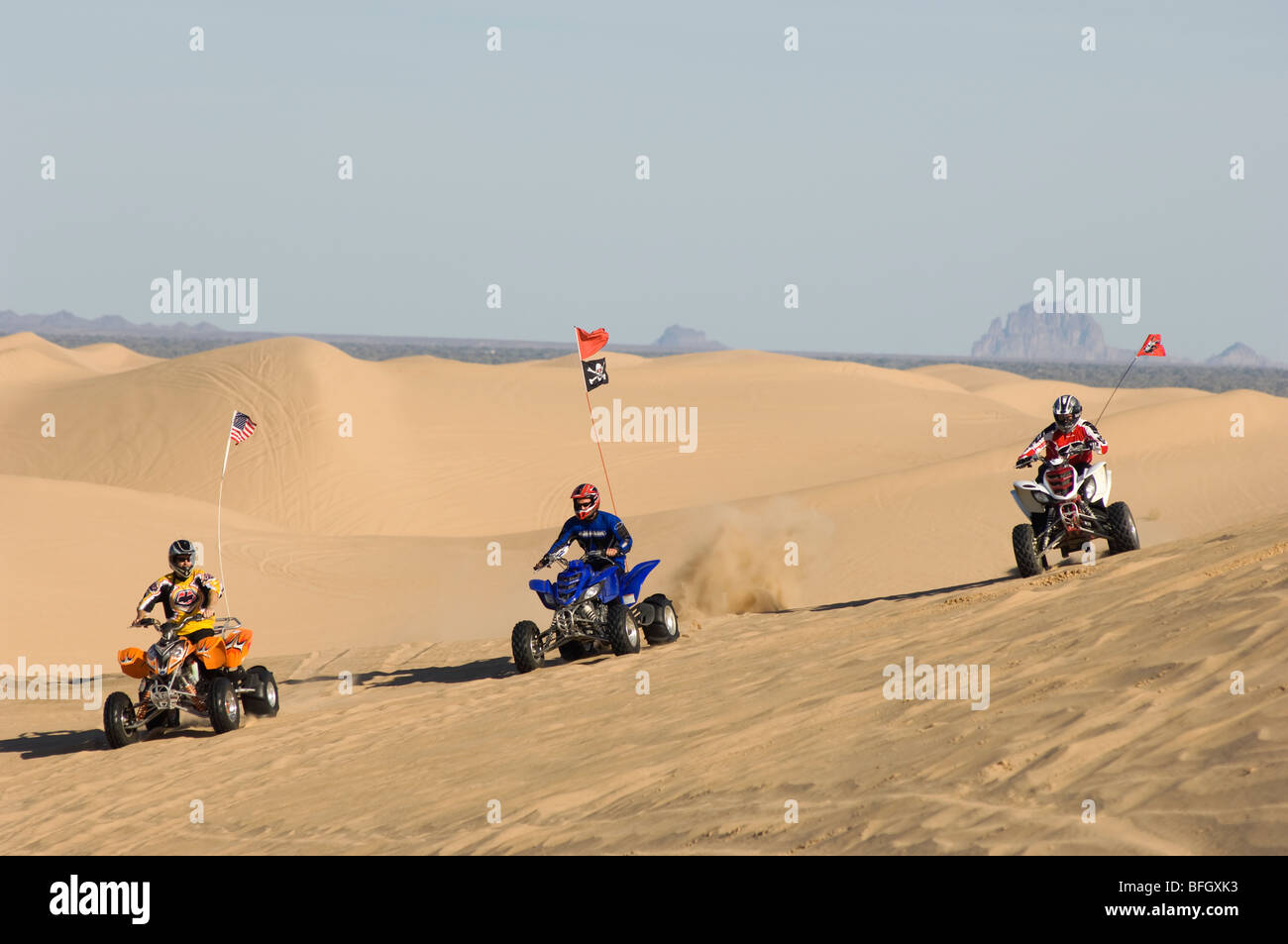Three Young Men Riding ATVs on Dunes Stock Photo - Alamy