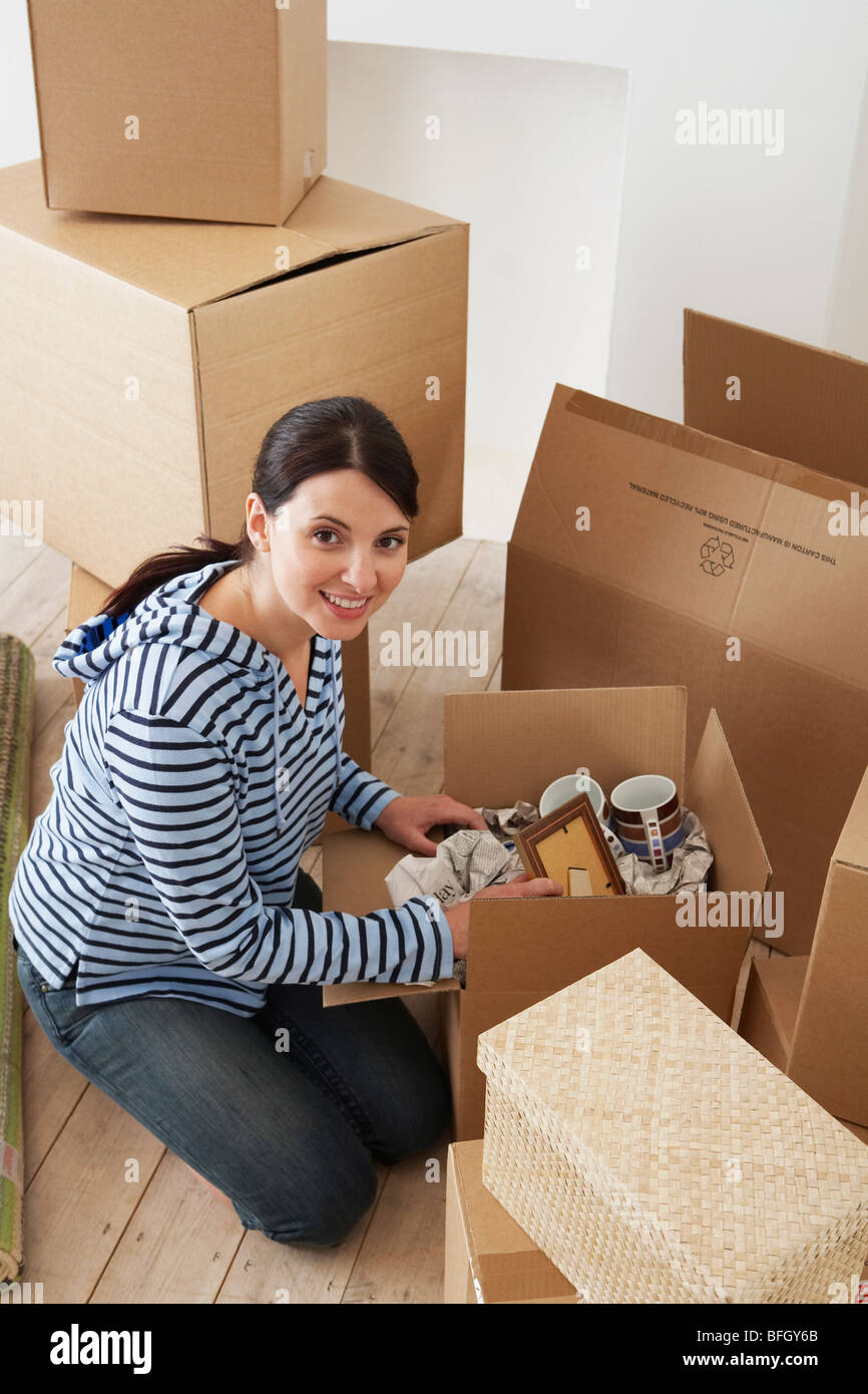 Young Woman Unpacking Boxes Stock Photo - Alamy