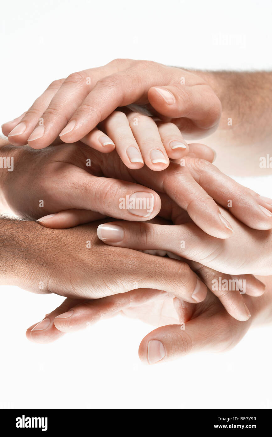 Young men and women stacking hands, close up of hands Stock Photo - Alamy