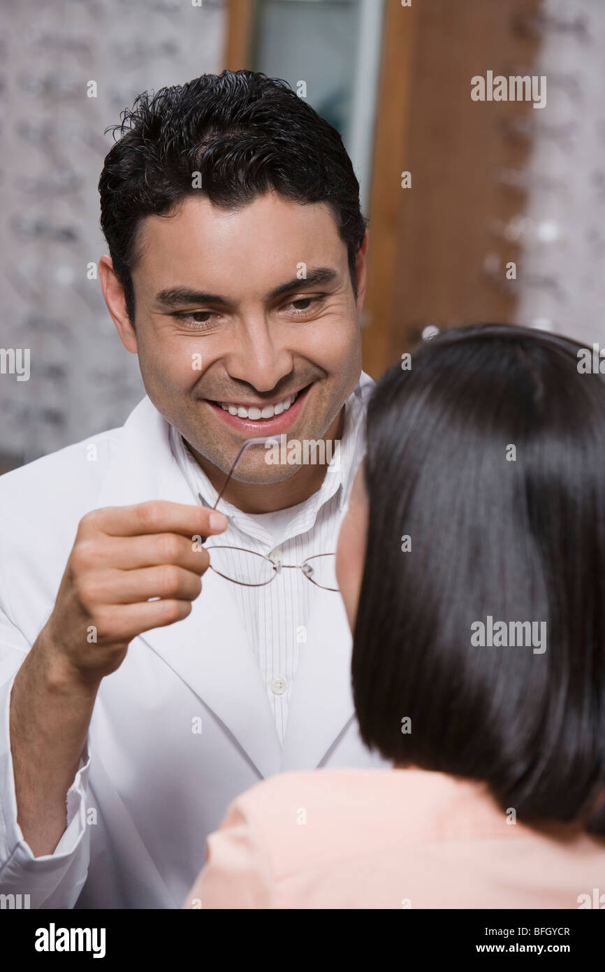 Optician helping customer Stock Photo - Alamy