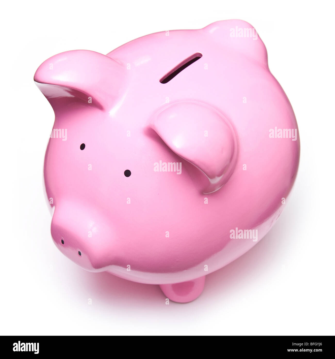 Pink piggy bank style money box isolated on a white studio background ...