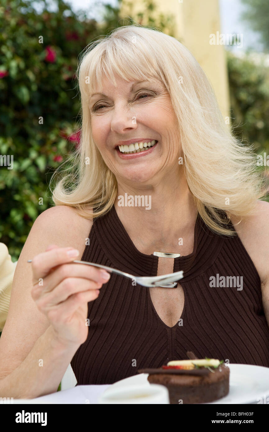 Woman eating dessert outdoors Stock Photo - Alamy