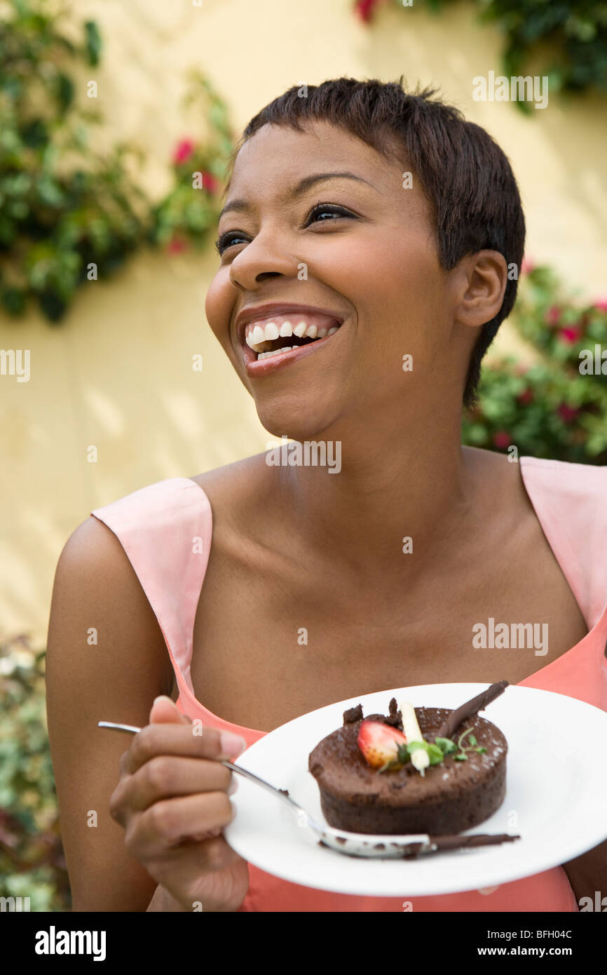 Woman eating dessert outdoors Stock Photo - Alamy