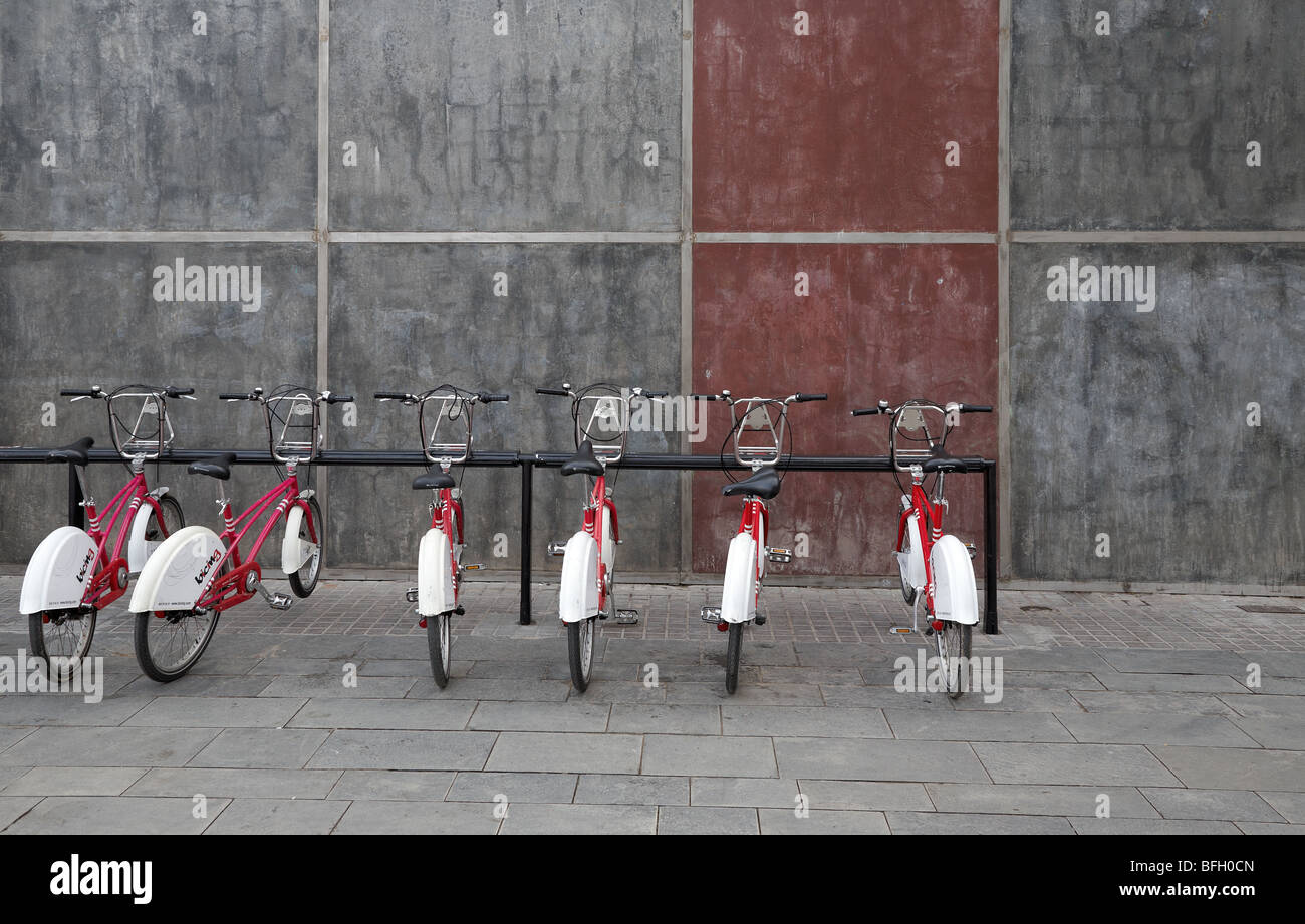 Pay as you go hire bikes on bike rack in Barcelona Stock Photo - Alamy