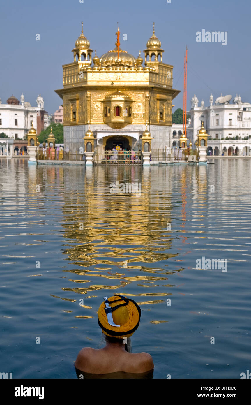 Sikh pilgrim bathing in the sacred pool (Amrit Sarovar). The Golden ...