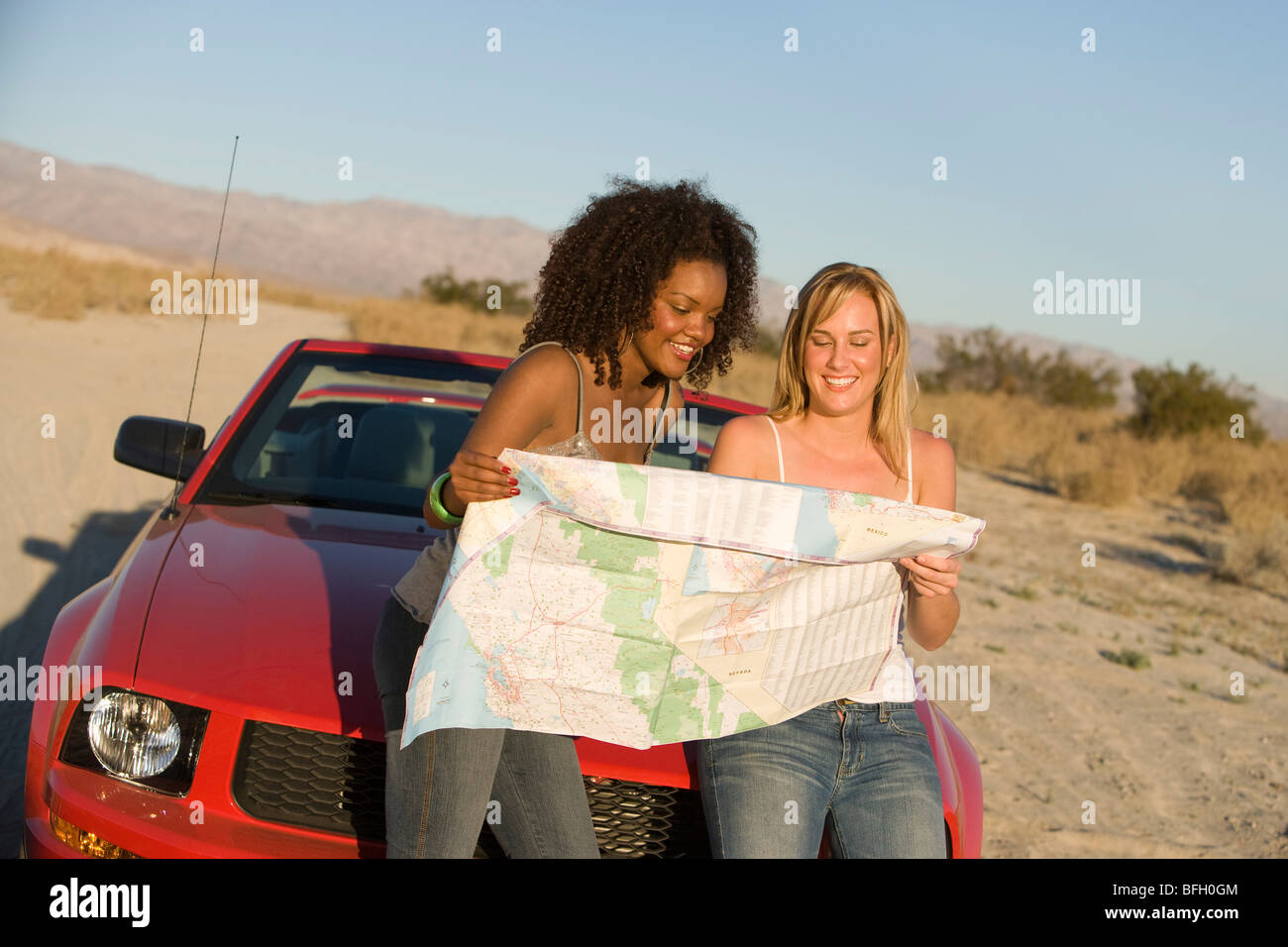 Women Looking at Road Map Stock Photo - Alamy