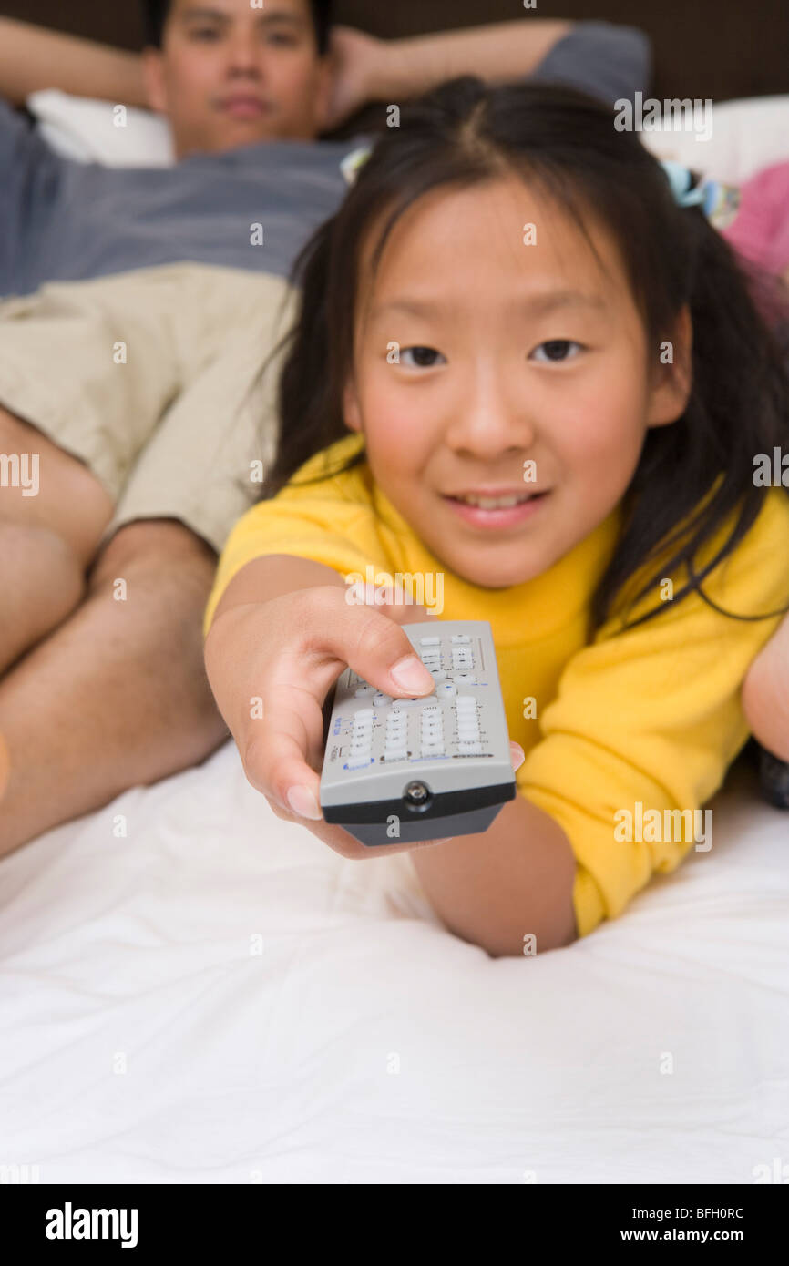 Girl holding remote control Stock Photo - Alamy