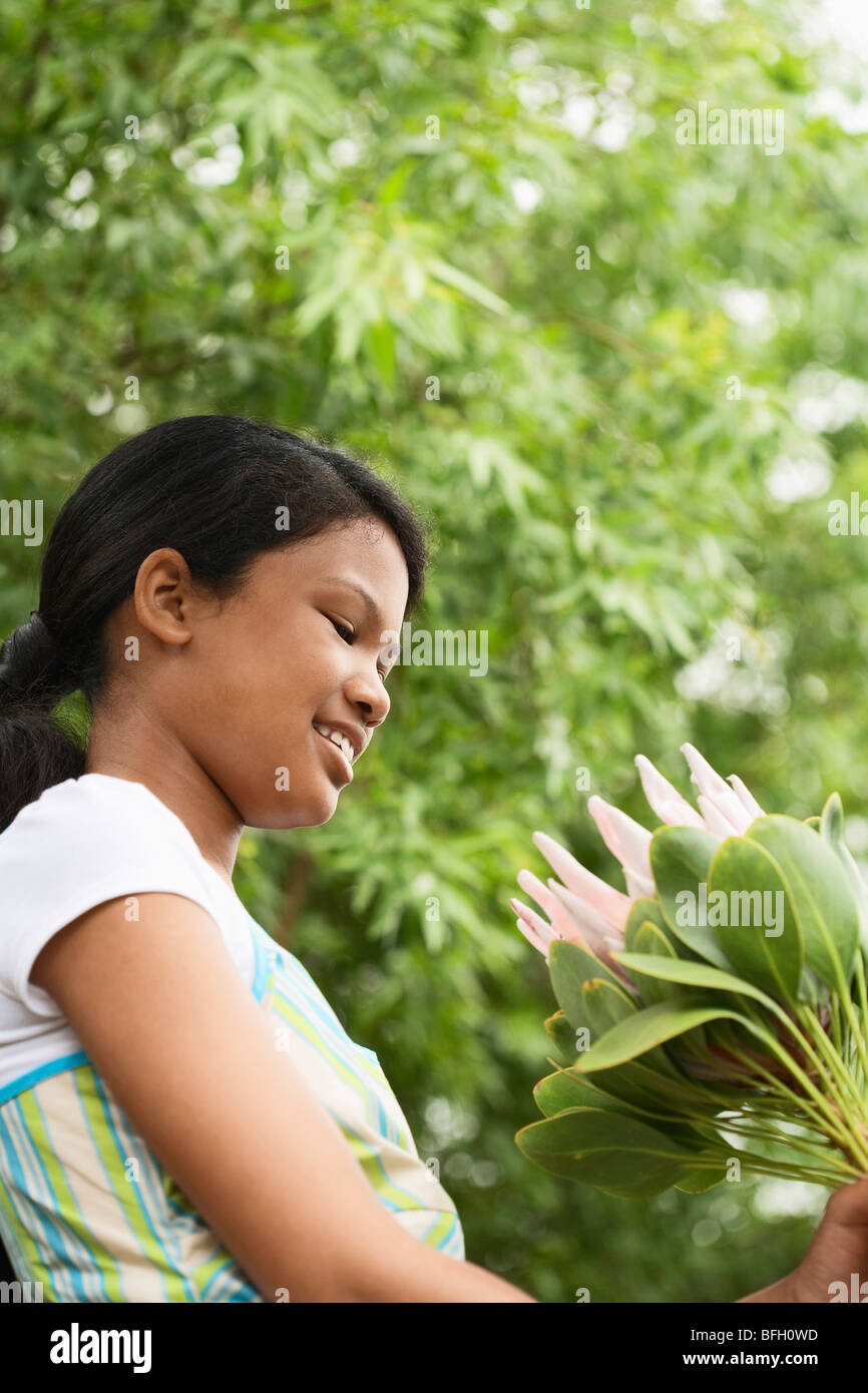Girl Looking at Flower Stock Photo - Alamy
