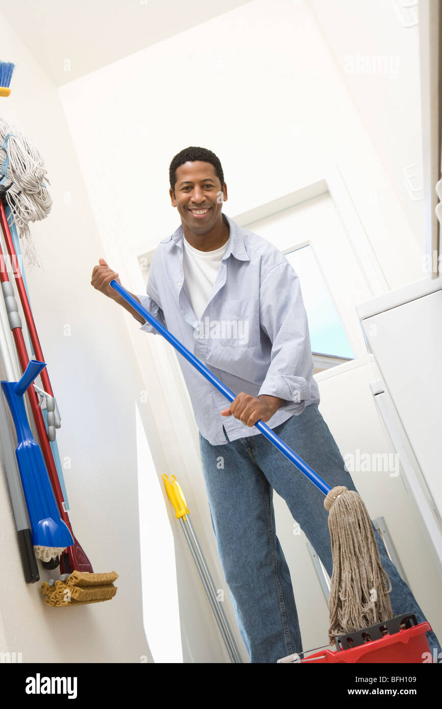Black man mopping floor hi-res stock photography and images - Alamy