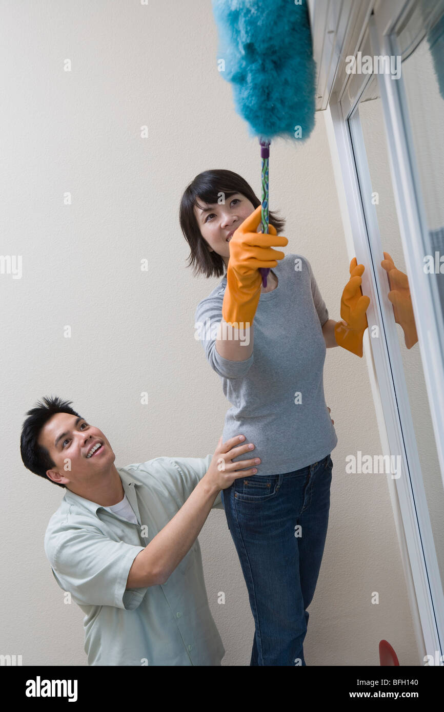 Couple cleaning house Stock Photo - Alamy