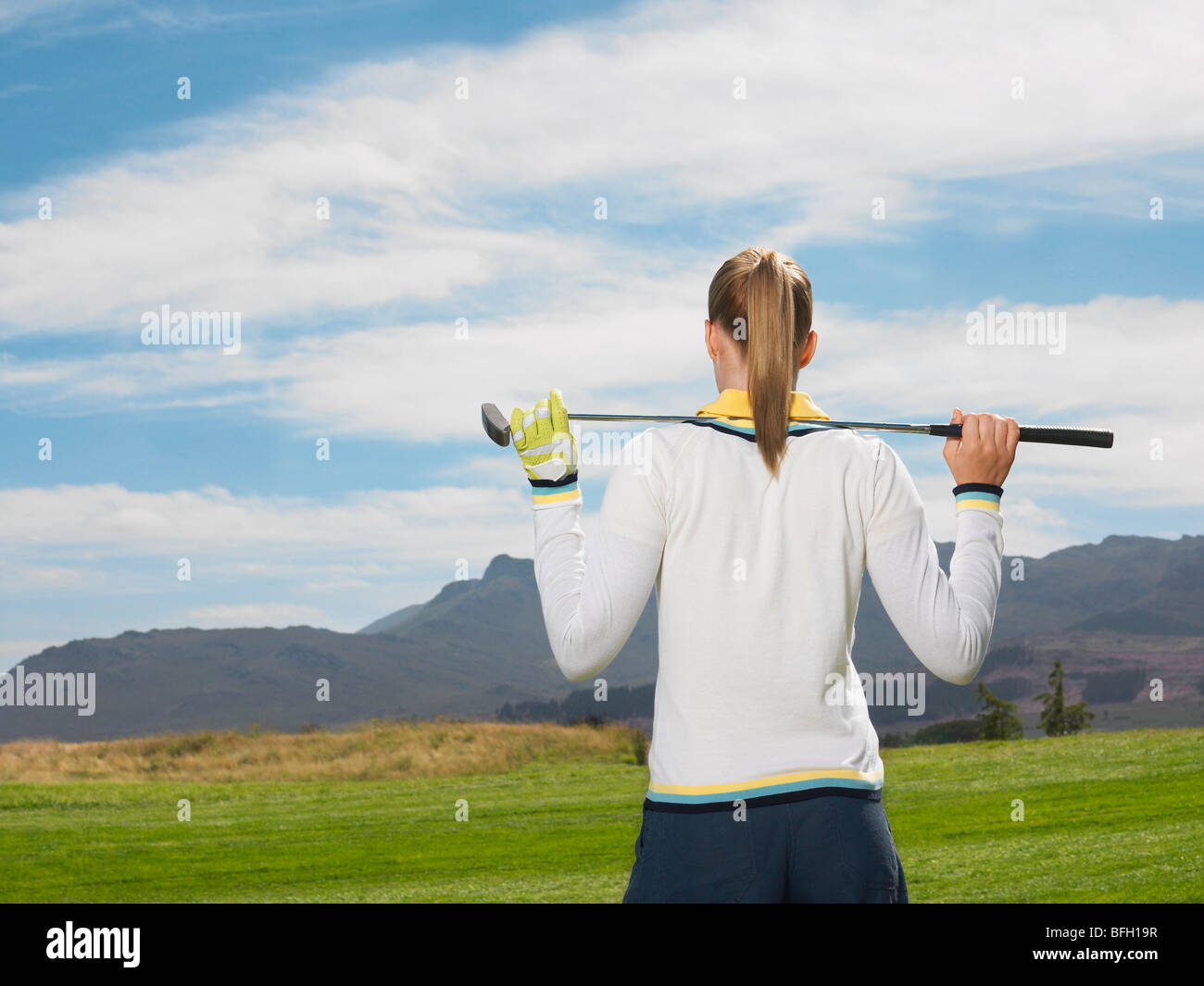 Young woman on golf course, back view Stock Photo - Alamy