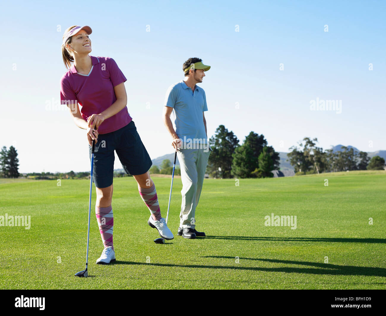 Two young golfers on course Stock Photo - Alamy