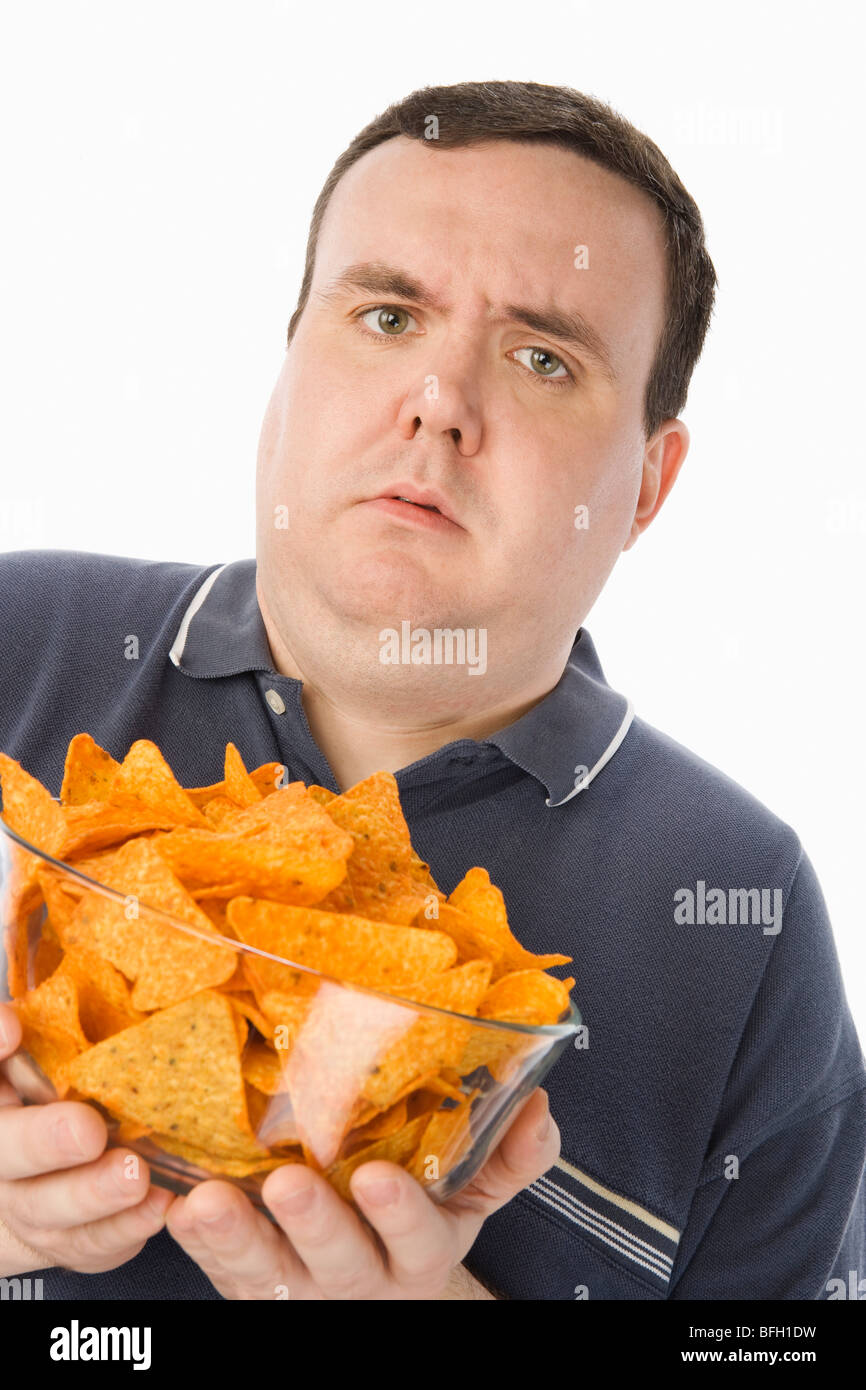 Overweight man eating chips hi-res stock photography and images - Alamy