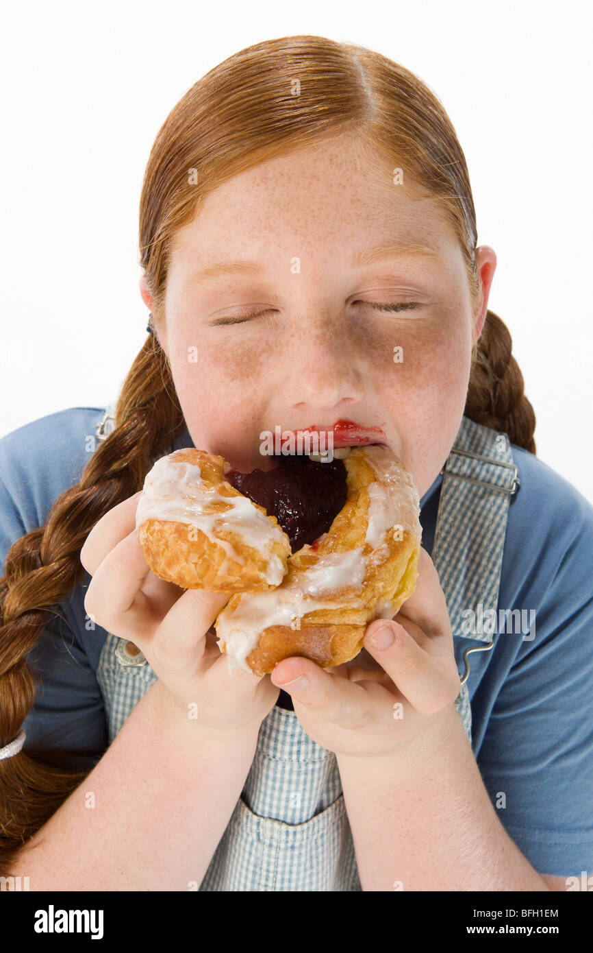 Overweight girl eating pastry, portrait Stock Photo - Alamy