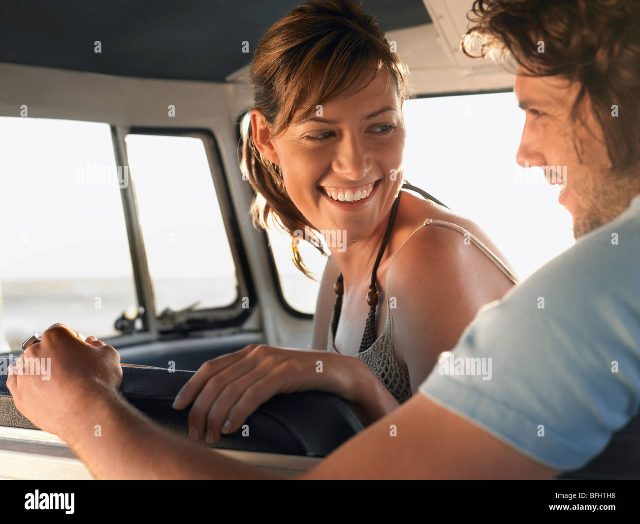 Young couple sitting in van, head and shoulders Stock Photo - Alamy