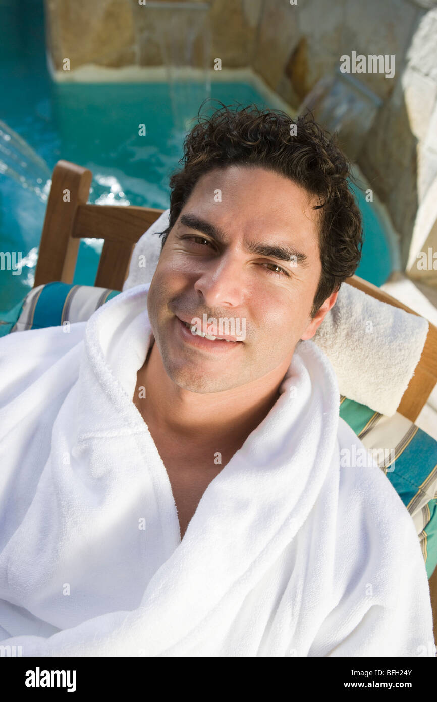 Portrait of man relaxing by swimming pool Stock Photo - Alamy
